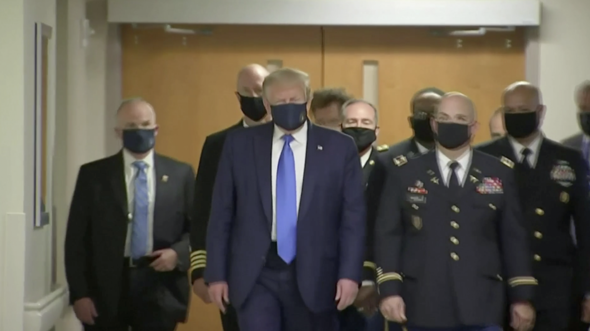 Donald Trump wears a face mask for the first time in public – as ...
